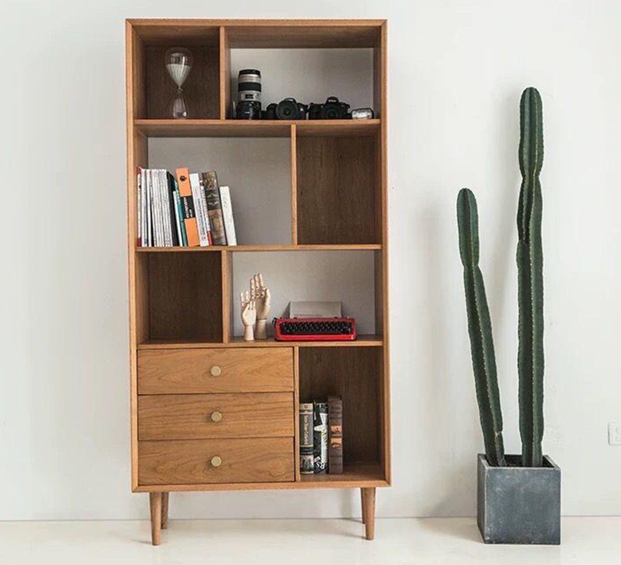 Modern bookcase with raised legs and three storage drawers – Vitrine ...